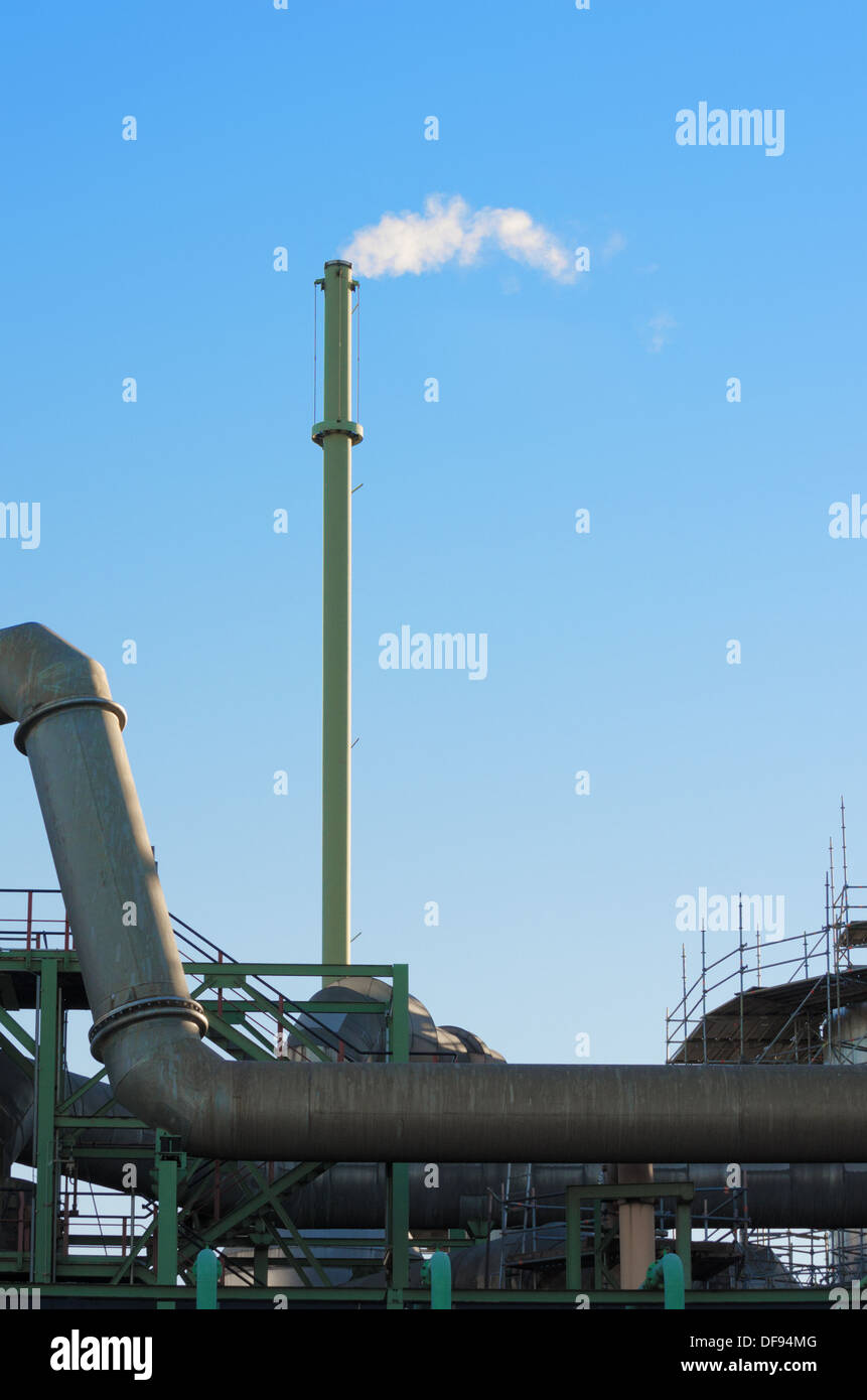 Smokestack of factory at a clear summer day. Vertical Stock Photo - Alamy