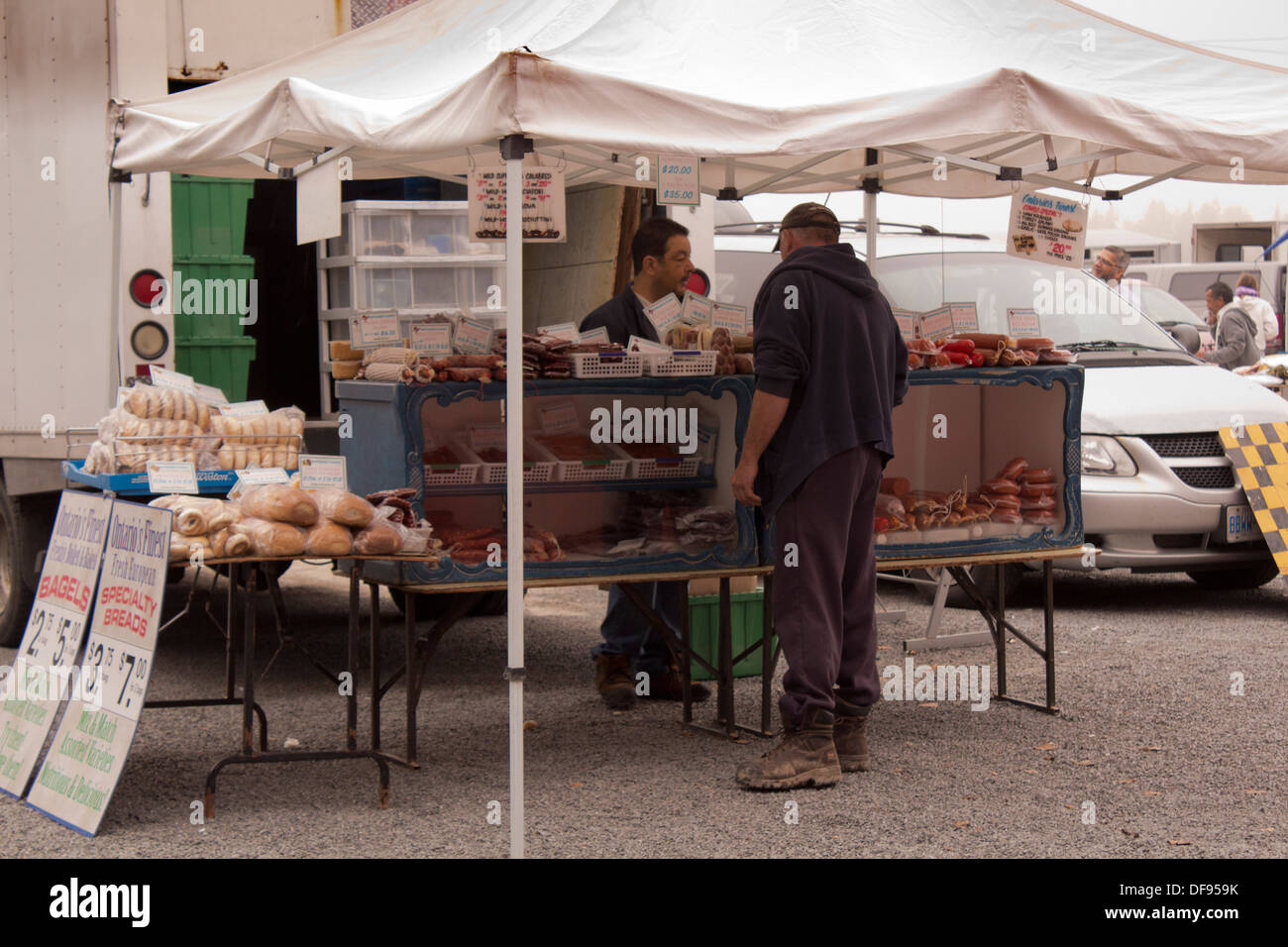 Meat and bread vendor at local auction under tent Stock Photo - Alamy