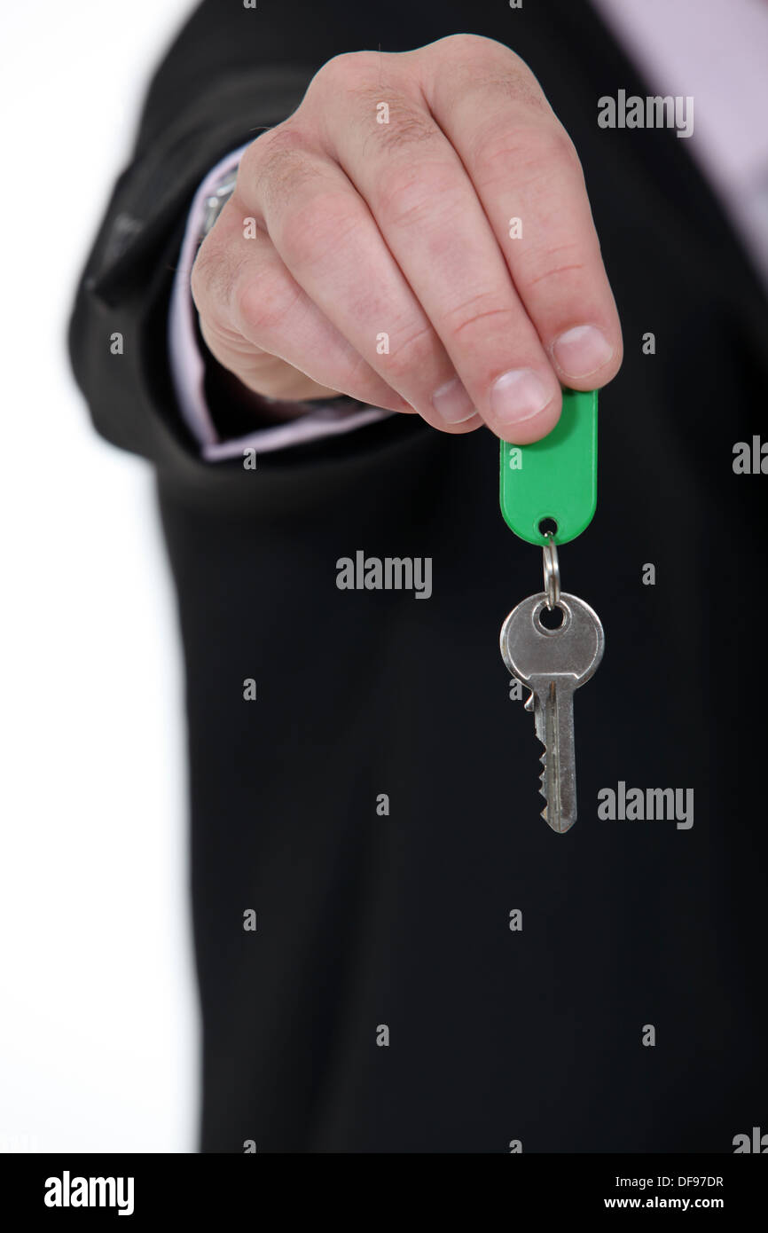 A cropped picture of a businessman handing a key Stock Photo - Alamy