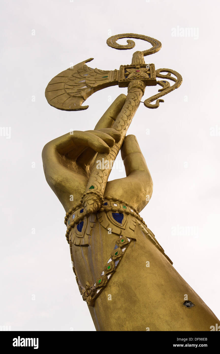 Hand With Axe of Golden statue of Ganesha Stock Photo - Alamy