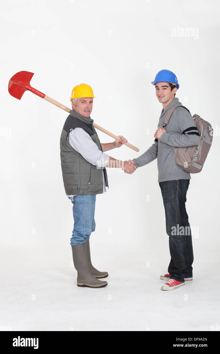 Construction workers handshaking Stock Photo - Alamy