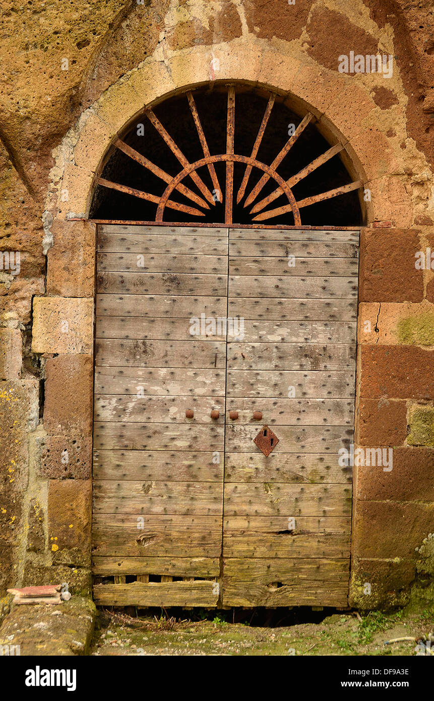 Old door at the entrance to storage room built into a cliff in ...