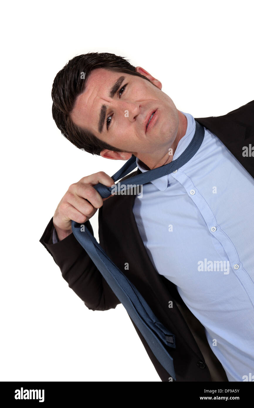 A businessman untying his tie Stock Photo - Alamy