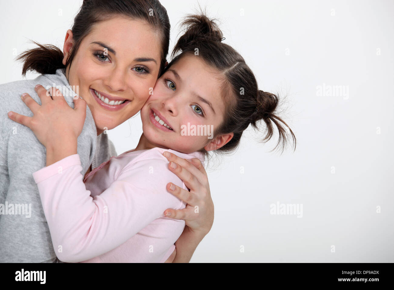 Mother hugging her daughter Stock Photo - Alamy