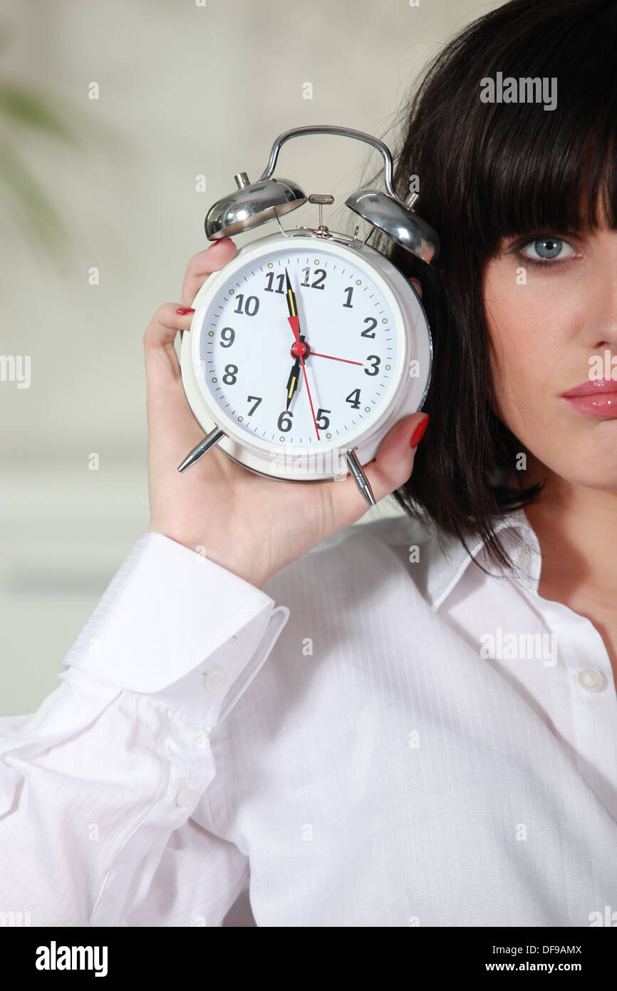Woman with clock Stock Photo - Alamy