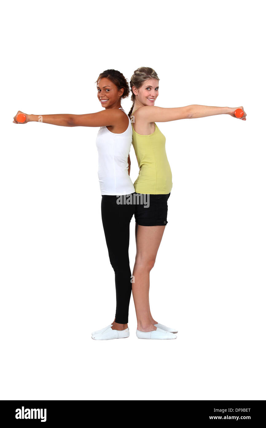 Two young women gym exercises Cut Out Stock Images & Pictures - Alamy
