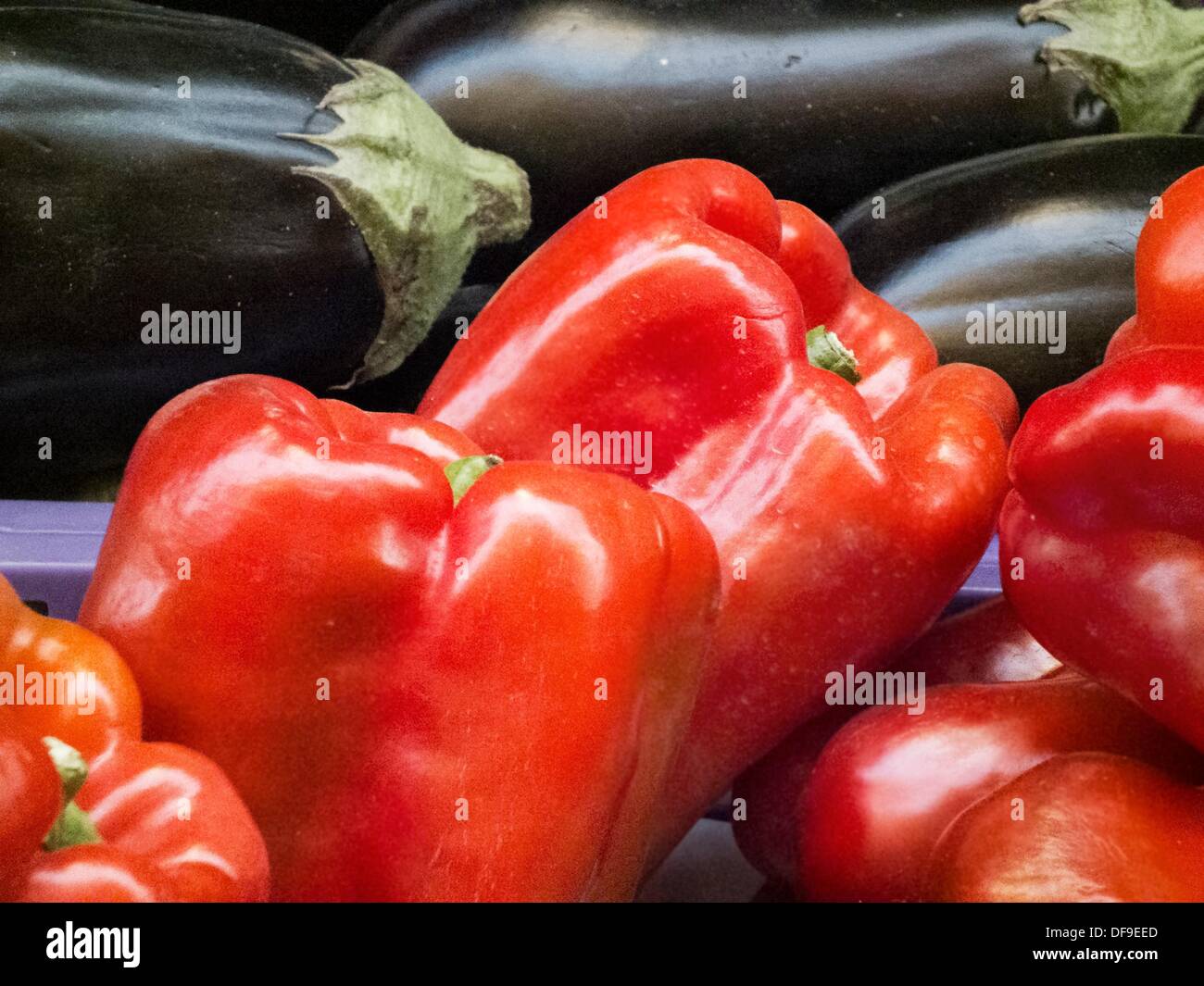 Vegetable boxes with red peppers and eggplant Stock Photo - Alamy