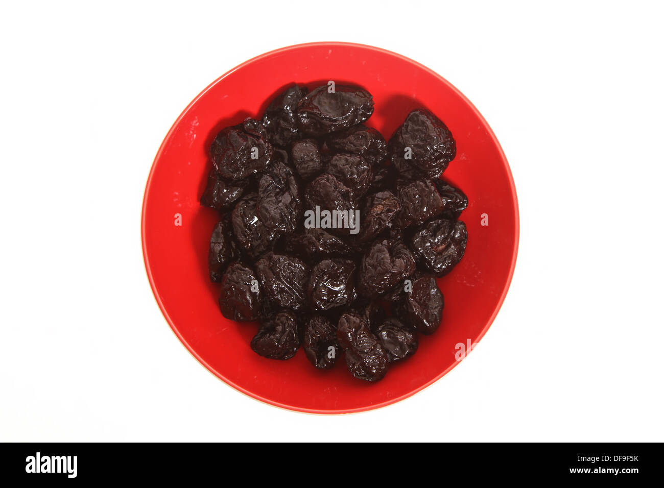 A pile of prunes on a bowl isolated Stock Photo - Alamy