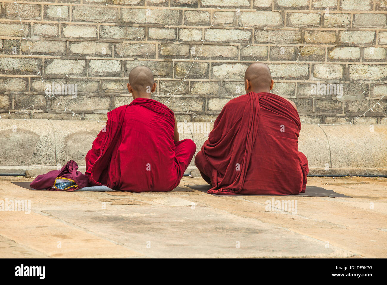 Buddhist monks praying at temple Stock Photo - Alamy