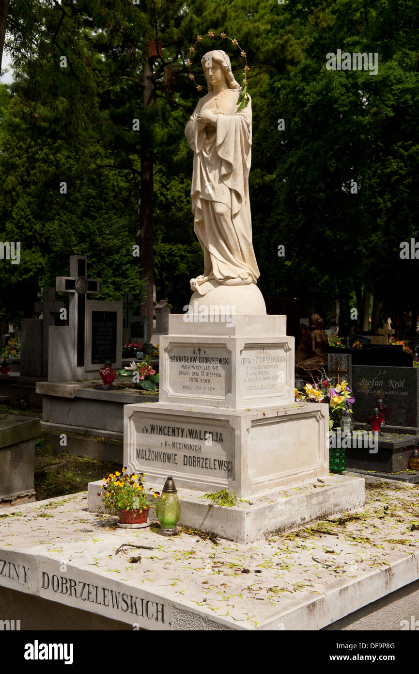 grave with Our Lady in aureole pray Stock Photo - Alamy