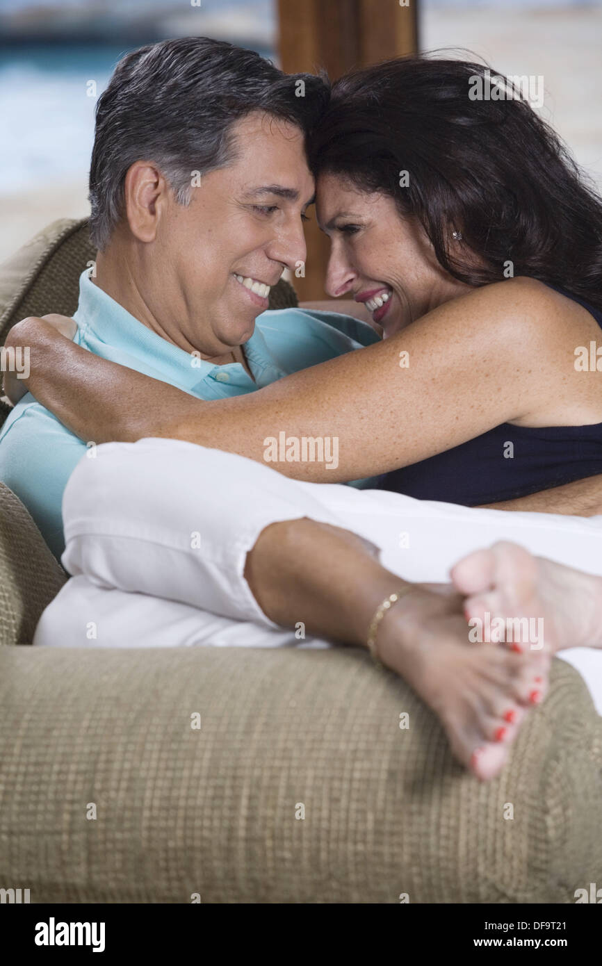 Couple embracing in armchair hi-res stock photography and images - Alamy