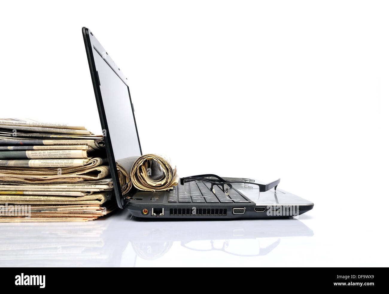 Laptop and newspapers on white background Stock Photo - Alamy