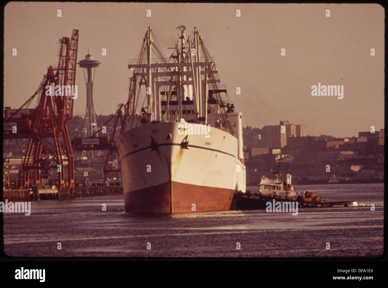 A tugboat assists in docking a freighter in the West Waterway of ...
