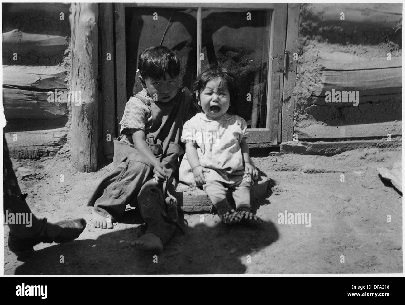 The photograph shows two Native American children, offering a glimpse ...