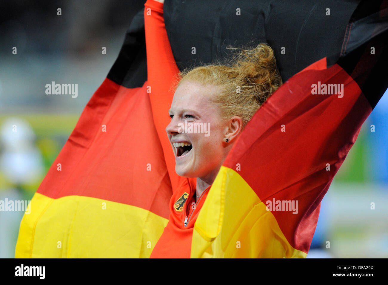 German hammer thrower Betti Heidler cheers and holds up the German flag ...