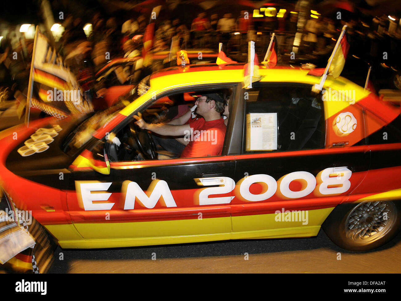 A car decorated with German colors and the slogan "EM 2008" is driving ...