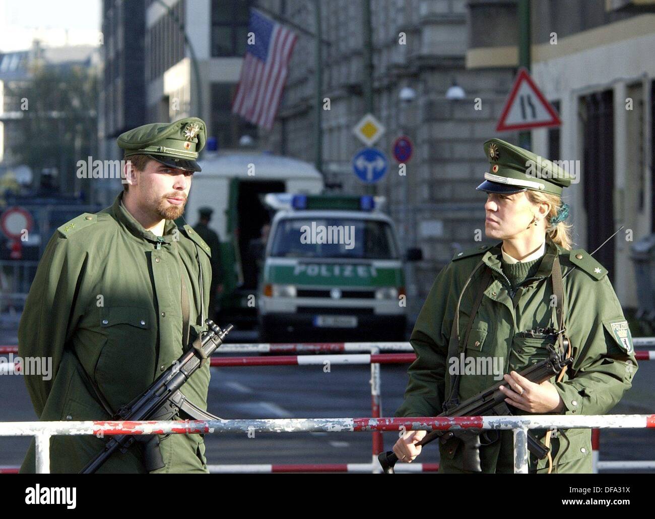 Two police officers carry machine guns to protect the US embassy in ...