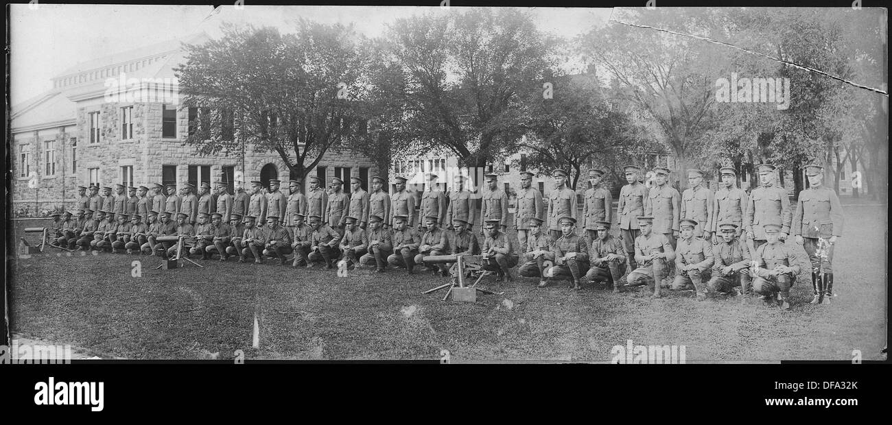 A group of uniformed soldiers poses for a photograph, showcasing ...