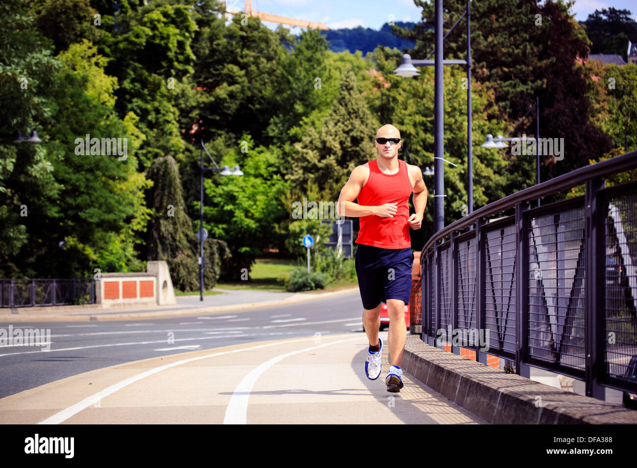 A young man jogging in the city Stock Photo - Alamy