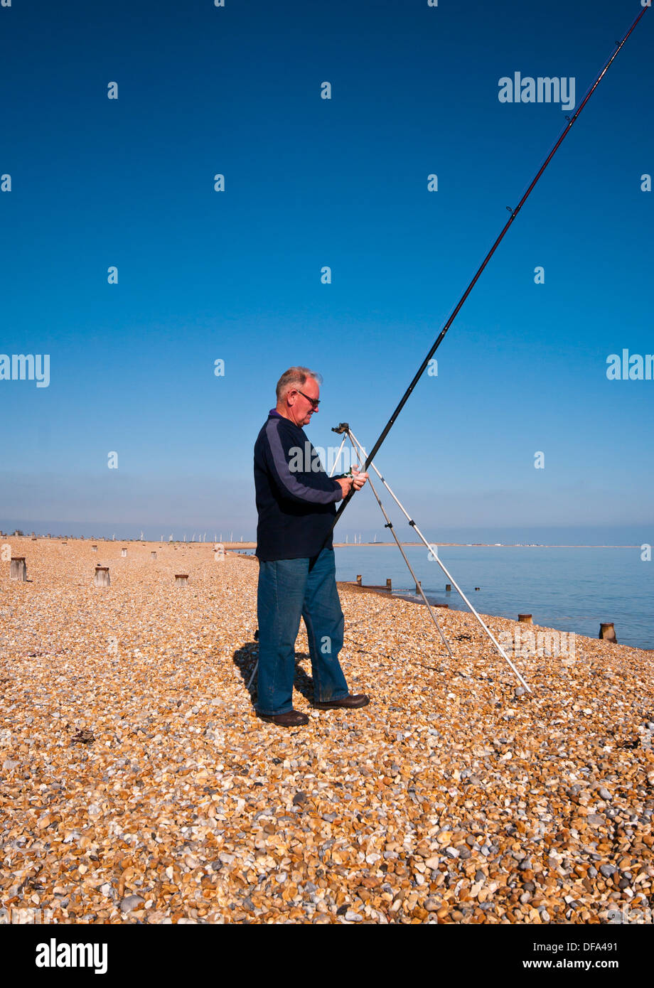 Beach Angler Fishing On A Shingle Beach UK Stock Photo - Alamy
