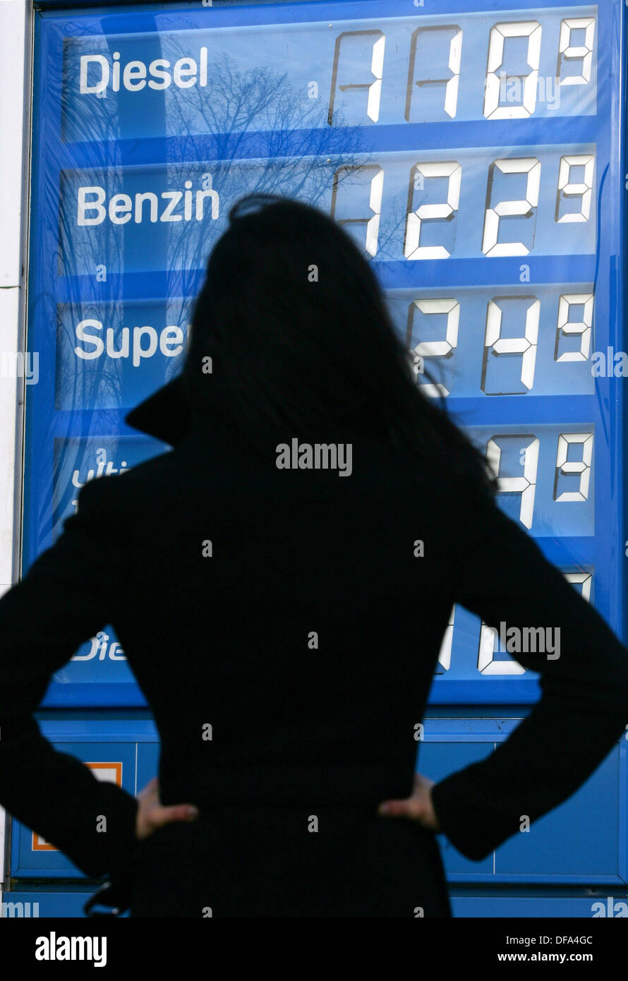 A symbolic picture for the gasoline price hike shows a woman in front ...