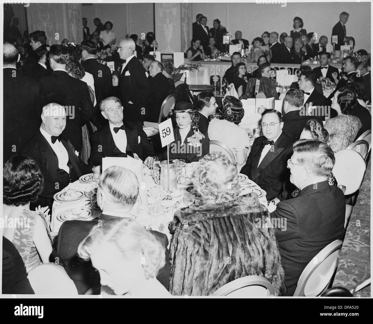 This photograph captures a view of the dinner table at an event ...