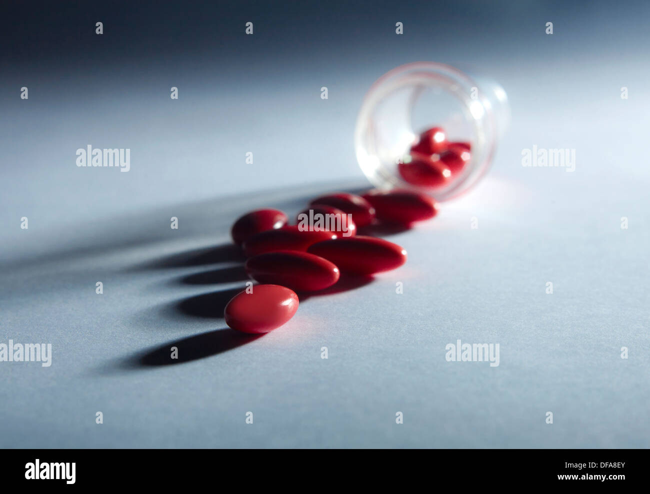 Spilled capsules from transparent prescription bottle Stock Photo - Alamy