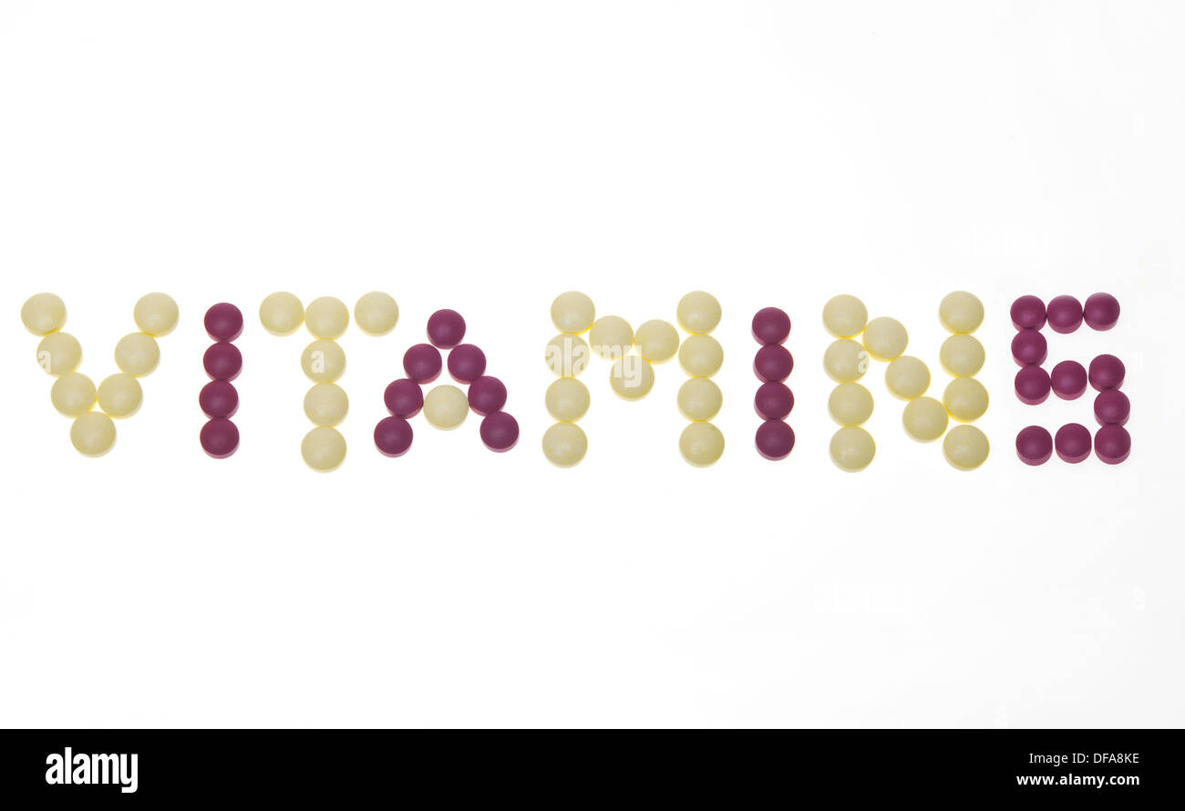 "Vitamins" text written with pills Stock Photo - Alamy
