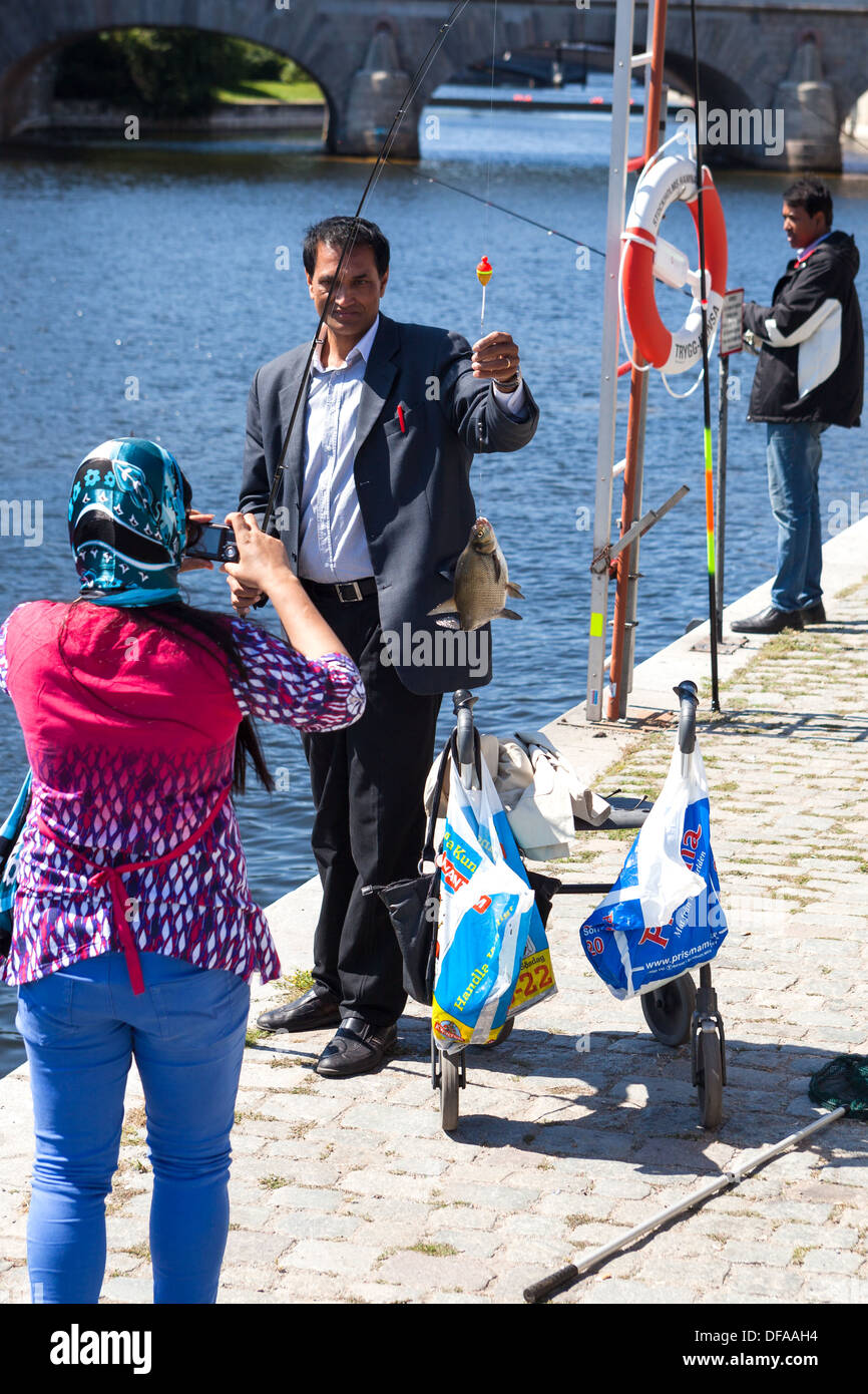 Woman catching fish hi-res stock photography and images - Alamy