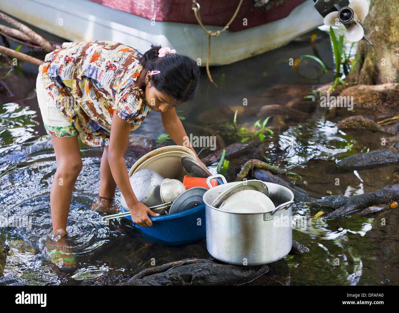 Girl washing dishes in river hi-res stock photography and images - Alamy