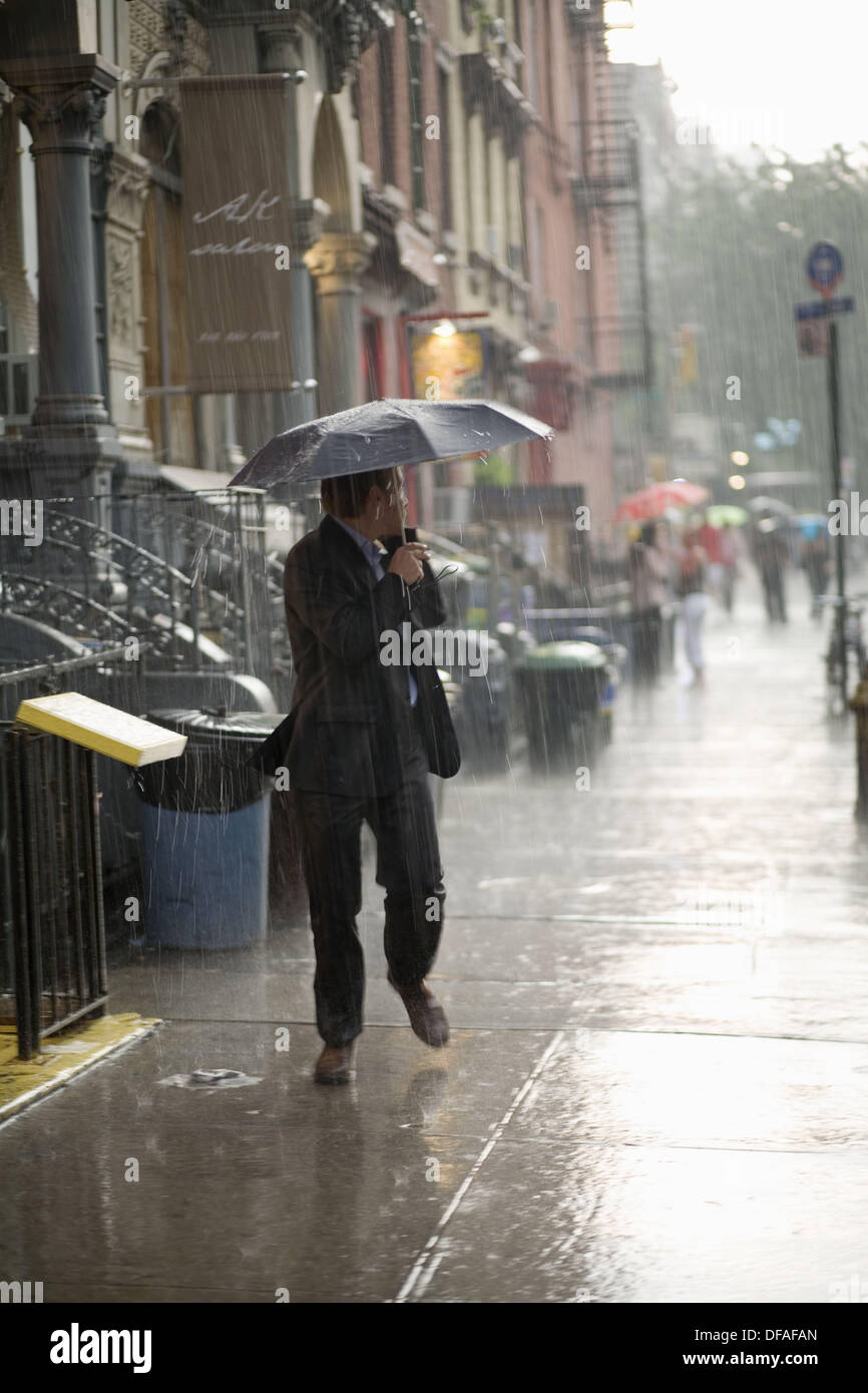 Businessman running rain hi-res stock photography and images - Alamy