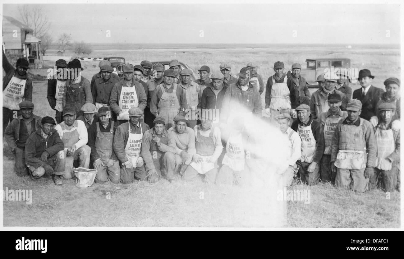 Workers at a community housing project are shown alongside ...