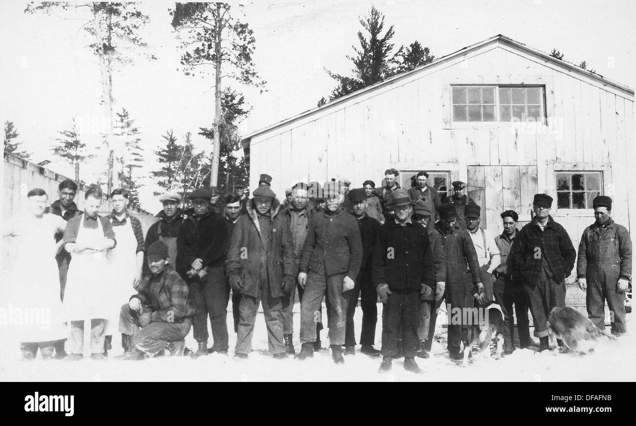 A work crew is posed for a photograph, likely documenting a team ...