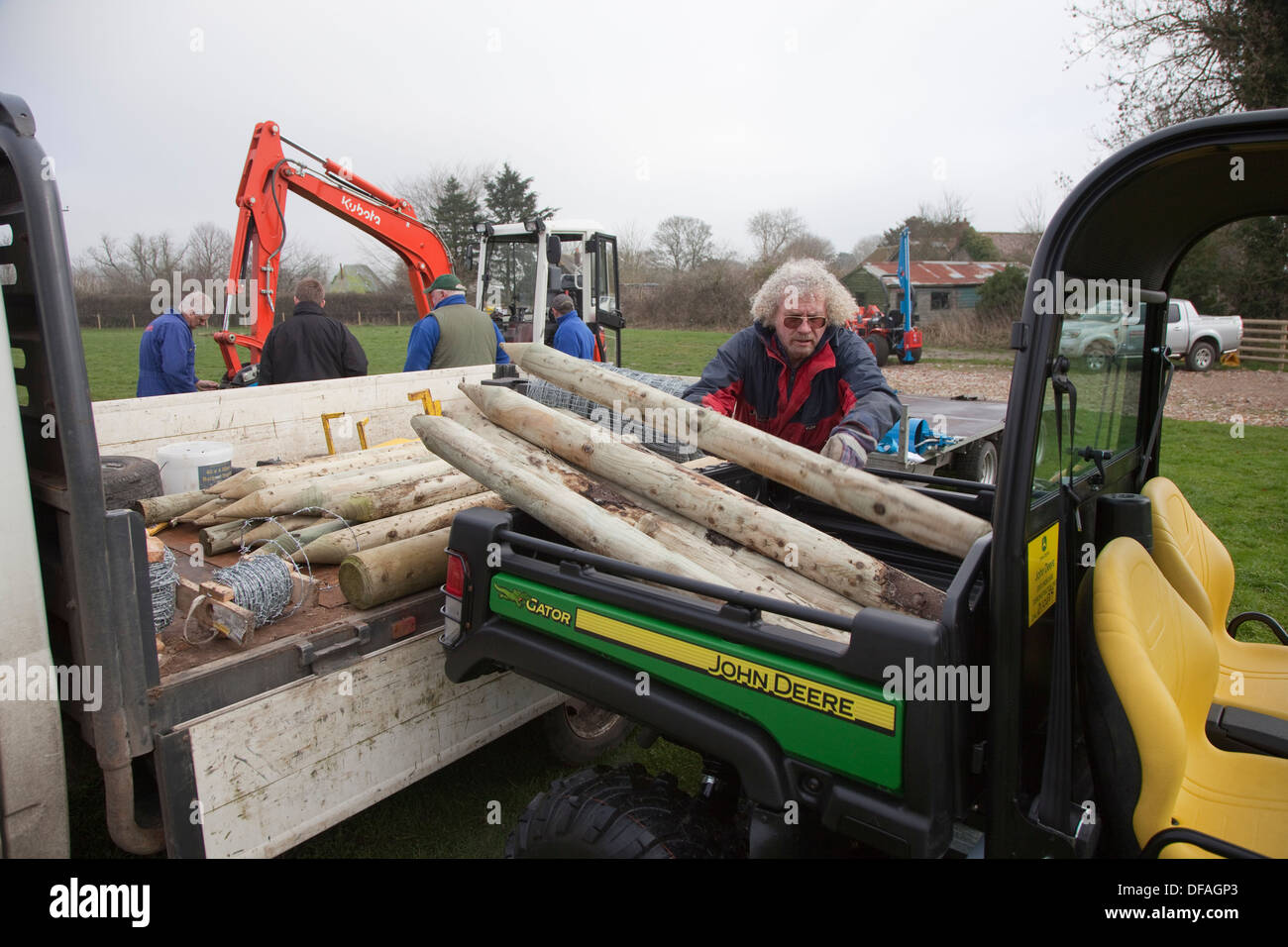 Loading fence posts on to a John Deere Gator UK Stock Photo - Alamy