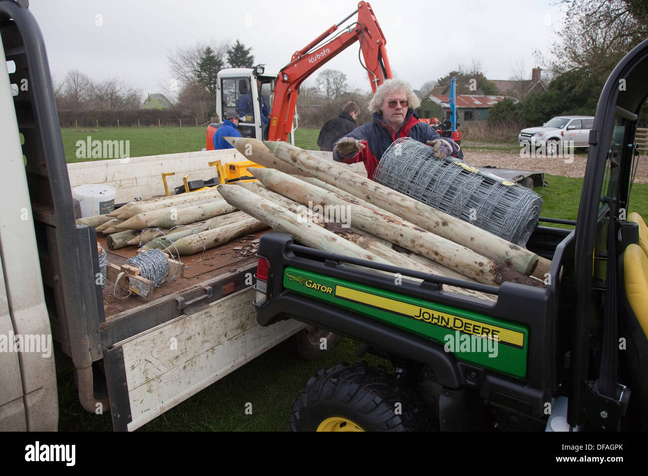 Loading fence posts on to a John Deere Gator UK Stock Photo - Alamy