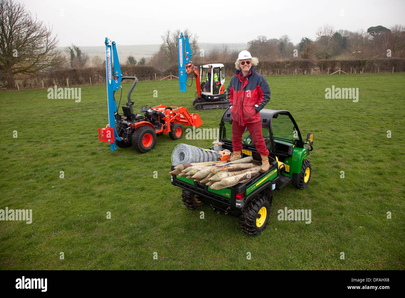 Workmen ready to create a fence using a Post Punching Machine UK Stock ...