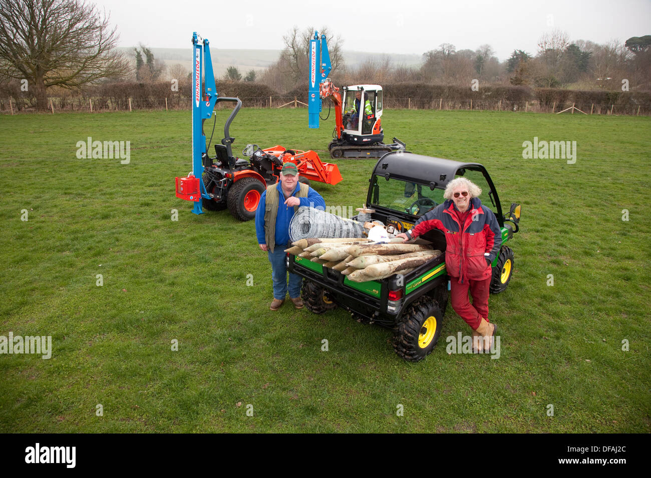 Workmen ready to create a fence using a Post Punching Machine UK Stock ...