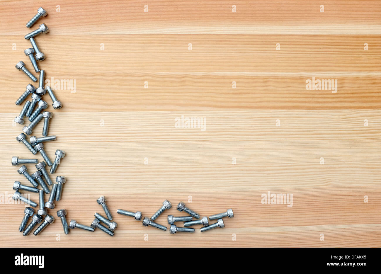 Socket head bolts as L-shape border on woodgrain background Stock Photo ...