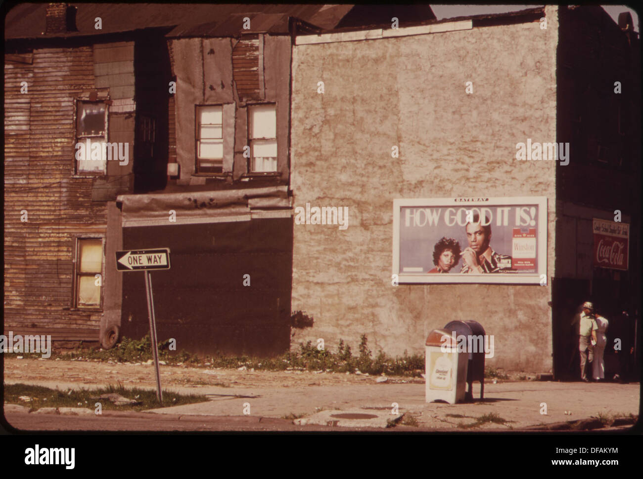 The photograph features a billboard with the slogan 'How Good It Is ...