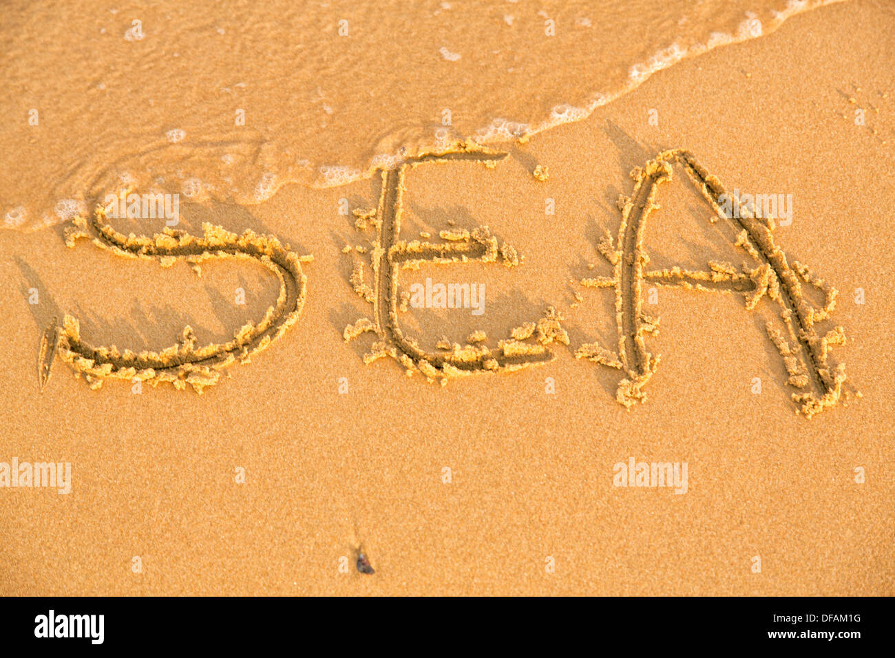 Word sea on the yellow sandy beach, text Stock Photo - Alamy