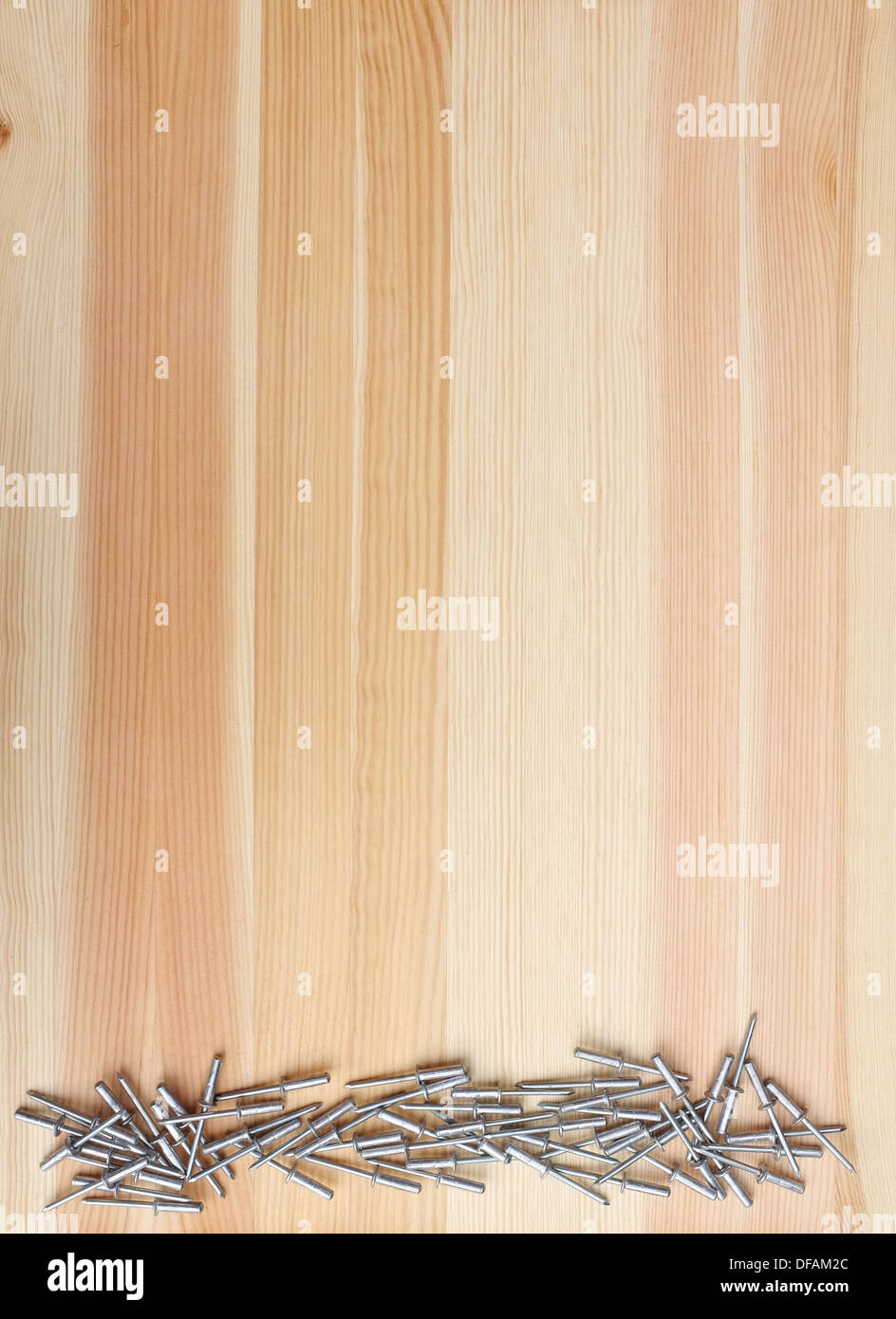 Metal pop rivets on a woodgrain background Stock Photo - Alamy
