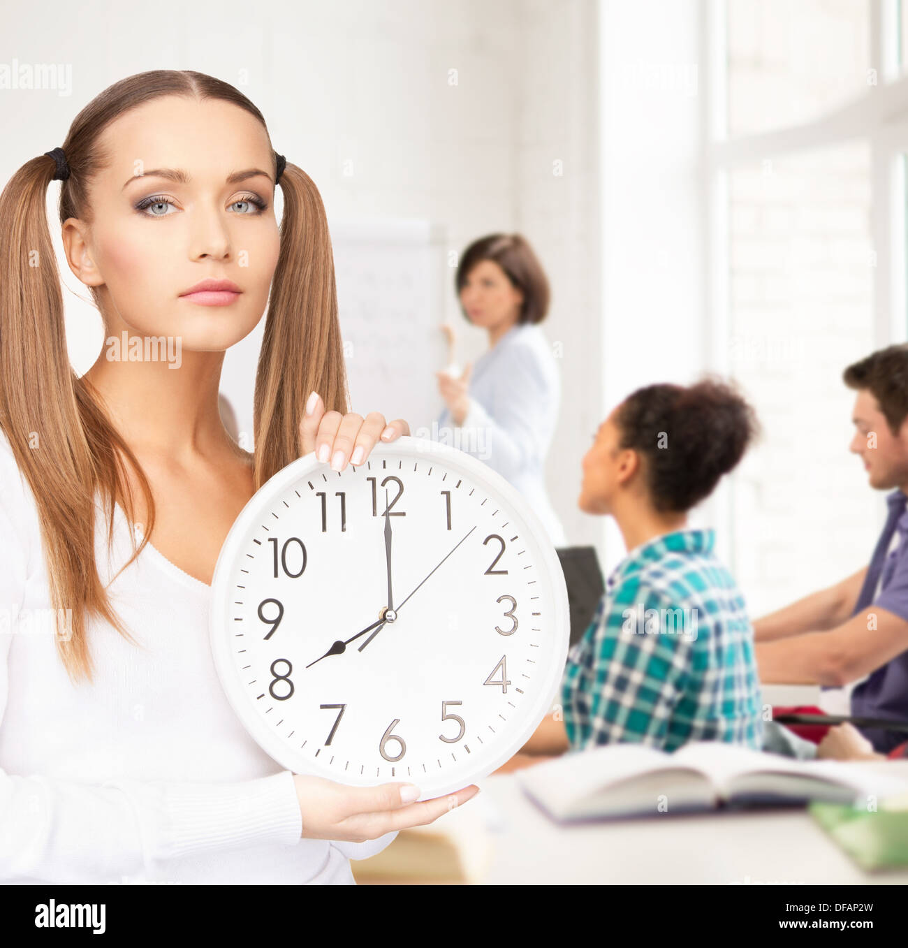 student showing clock Stock Photo - Alamy