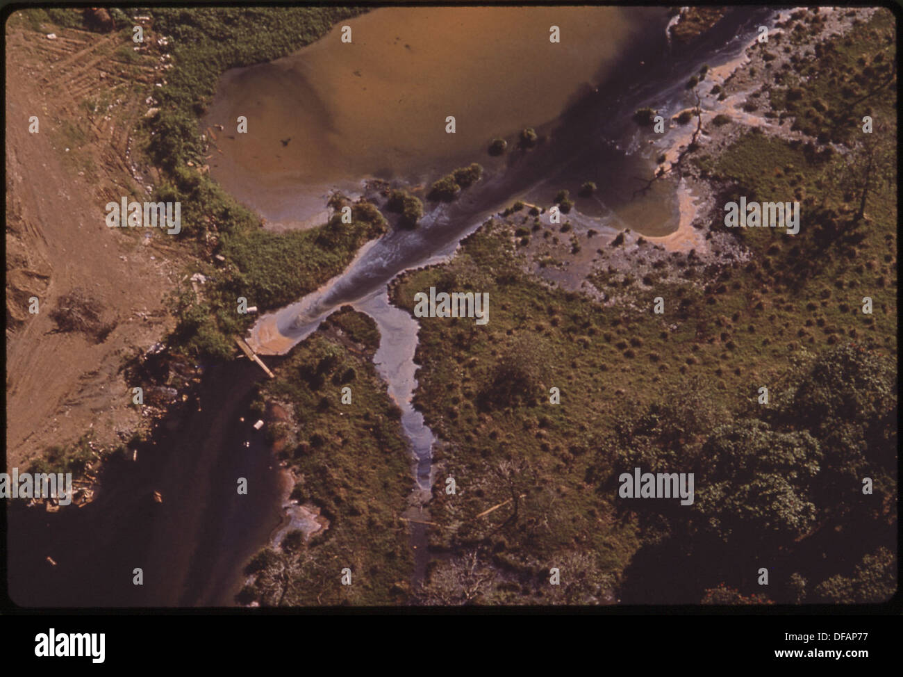 This aerial view shows a body of polluted water, highlighting the ...