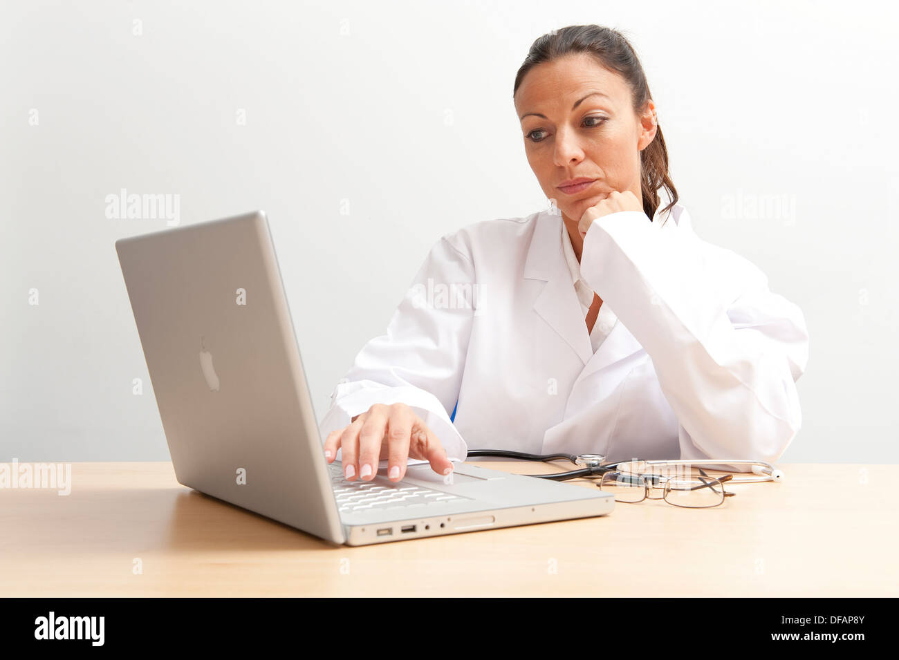 female doctor using laptop computer on office desk Stock Photo - Alamy