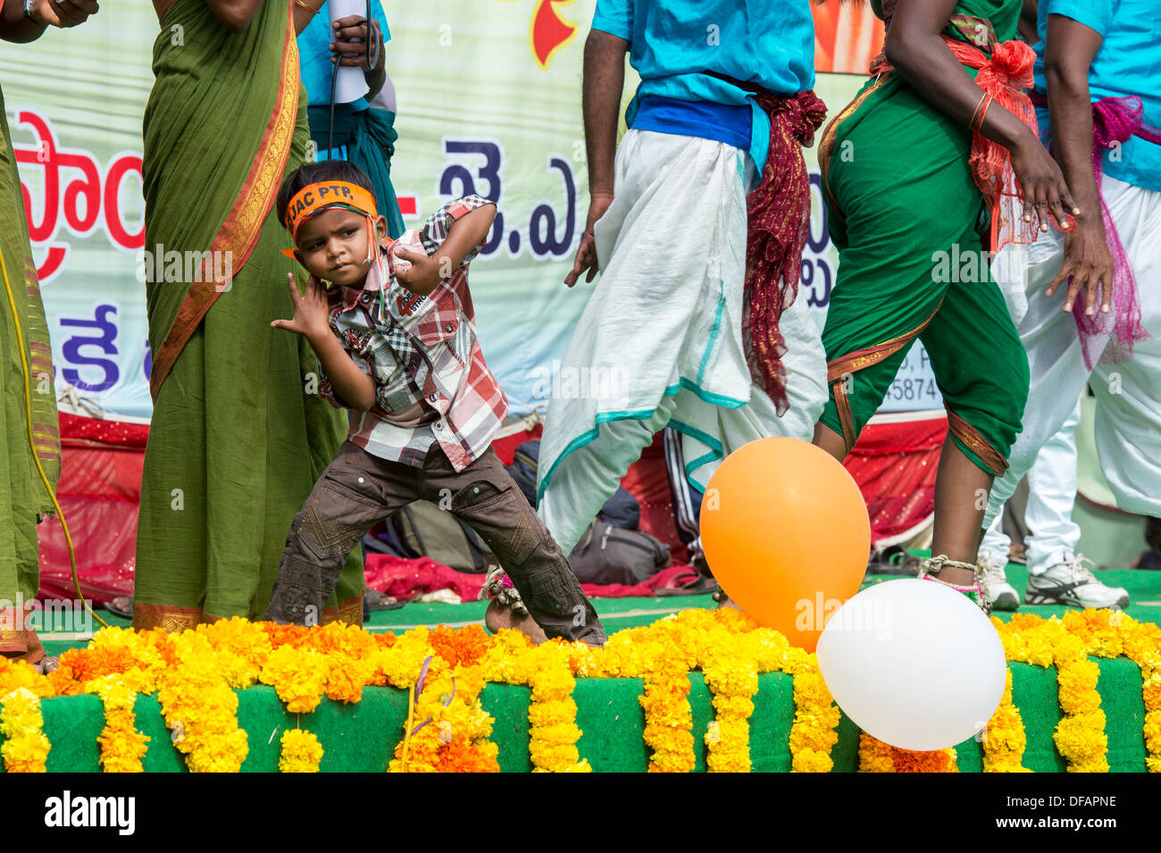 Very Young Indian boy dancing on stage at a protest rally. Puttaparthi ...
