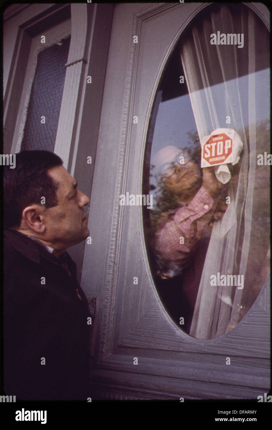 Anthony Bruno affixes a protest sticker to the front door of his ...