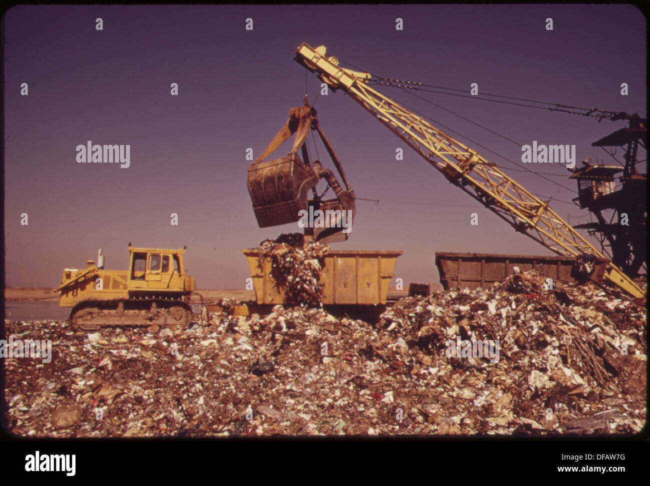 AT STATEN ISLAND LANDFILL STEAM SHOVEL LOADS CARTS WITH GARBAGE BROUGHT ...