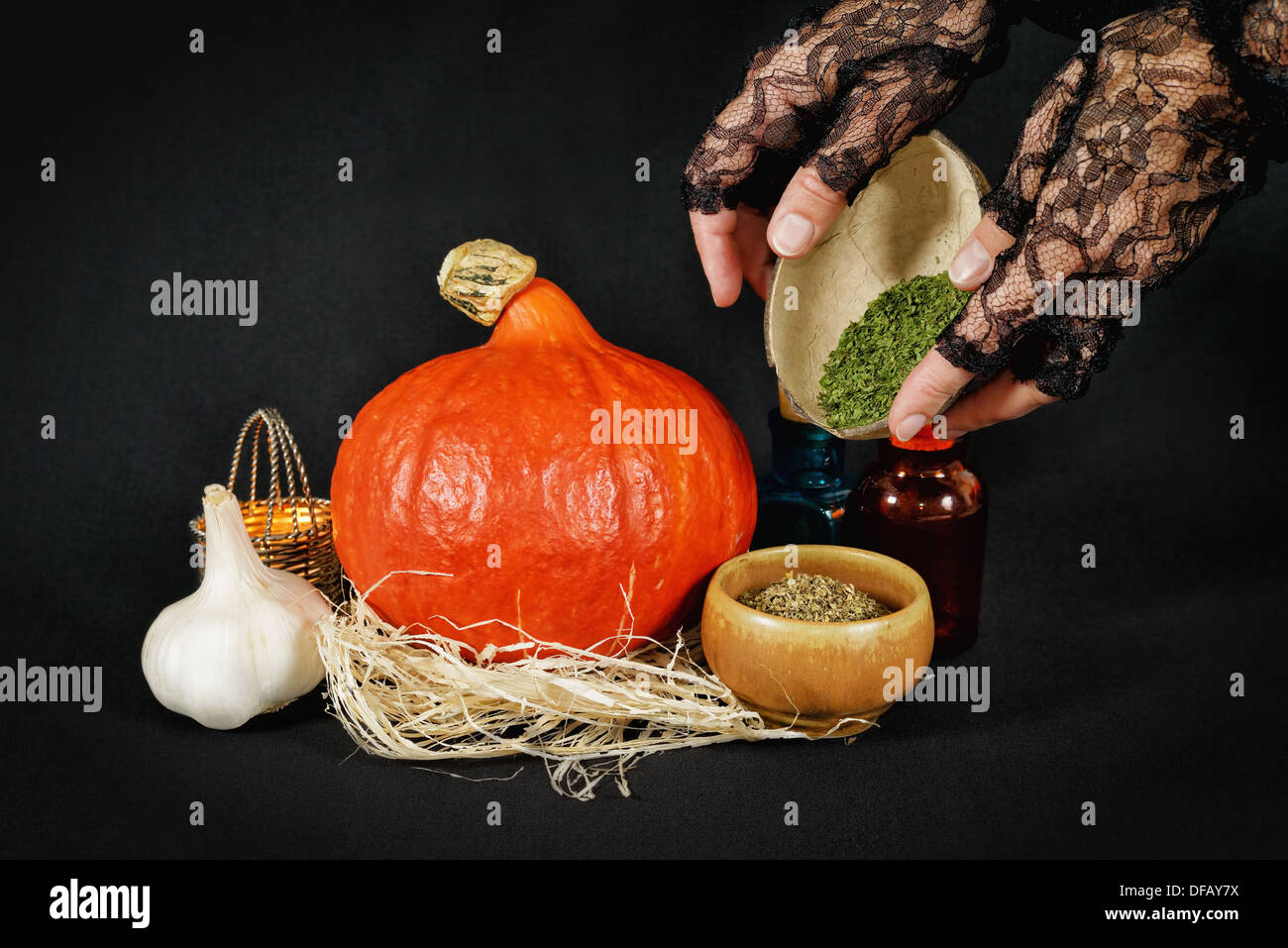 Witch preparing herbal mix for Halloween party in dark room Stock Photo ...