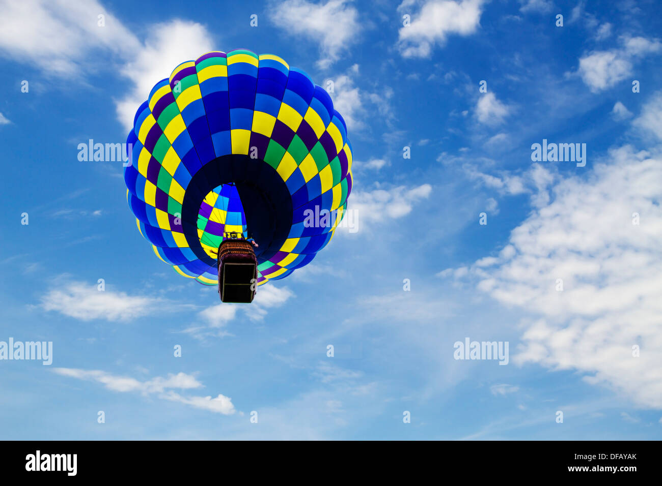 A hot air balloon in flight in a cloudy summer day Stock Photo - Alamy