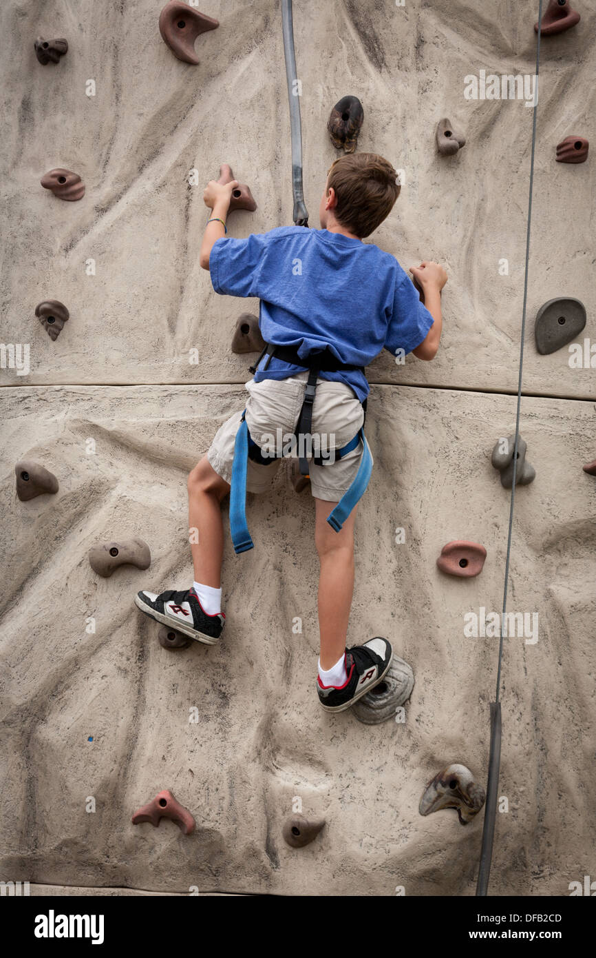 Boy at climbing wall game, Great New York State Fair Stock Photo - Alamy